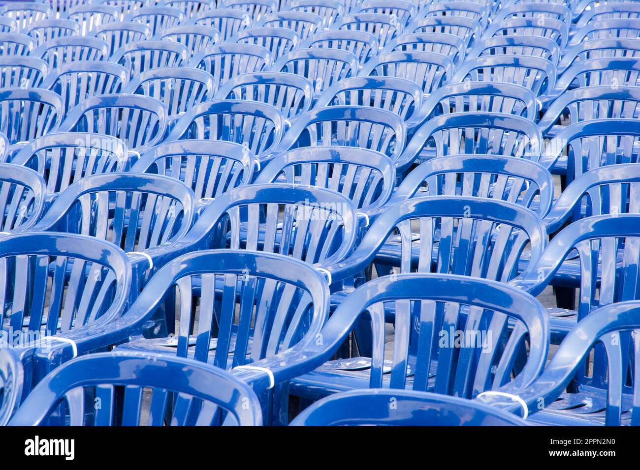 Many rows with a lot of blue pastic chairs Stock Photo - Alamy