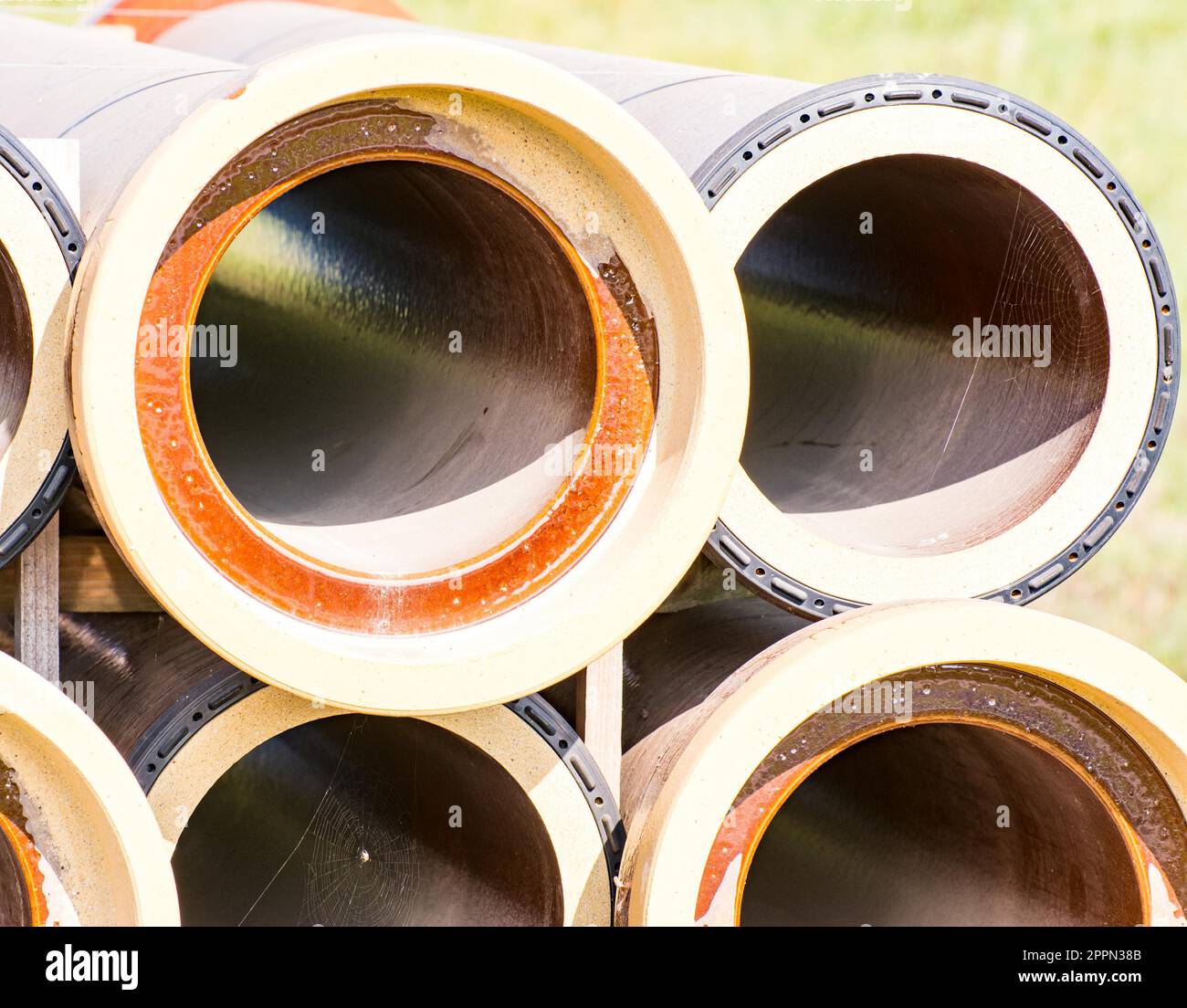 Stack of canalization pipes at a construction site Stock Photo - Alamy
