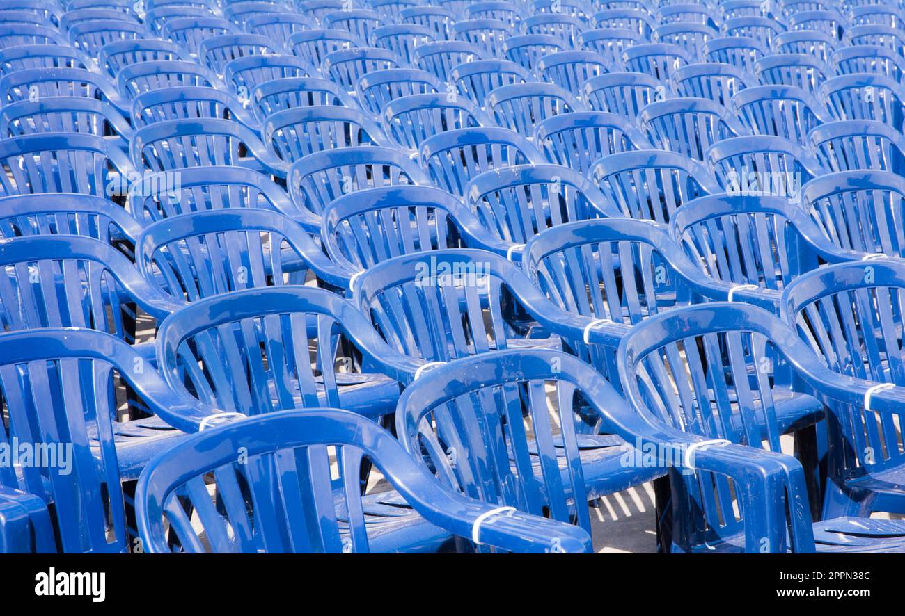 Many rows with a lot of blue pastic chairs Stock Photo - Alamy