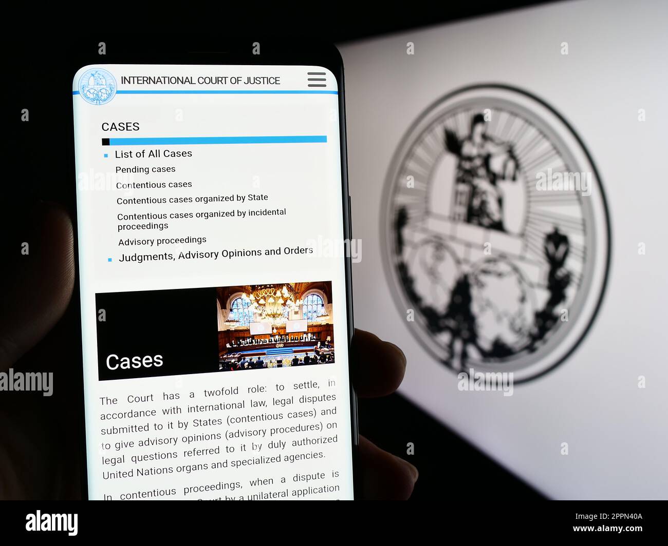 Person holding smartphone with web page of the International Court of ...