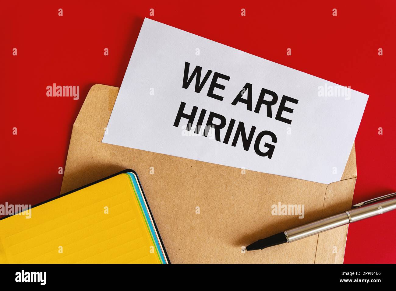 "Hiring Announcement on Red Background" - A white paper with a hiring ...