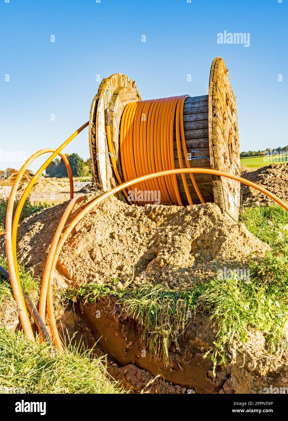 Construction site with a fiber optic cable roll for digital broadband ...