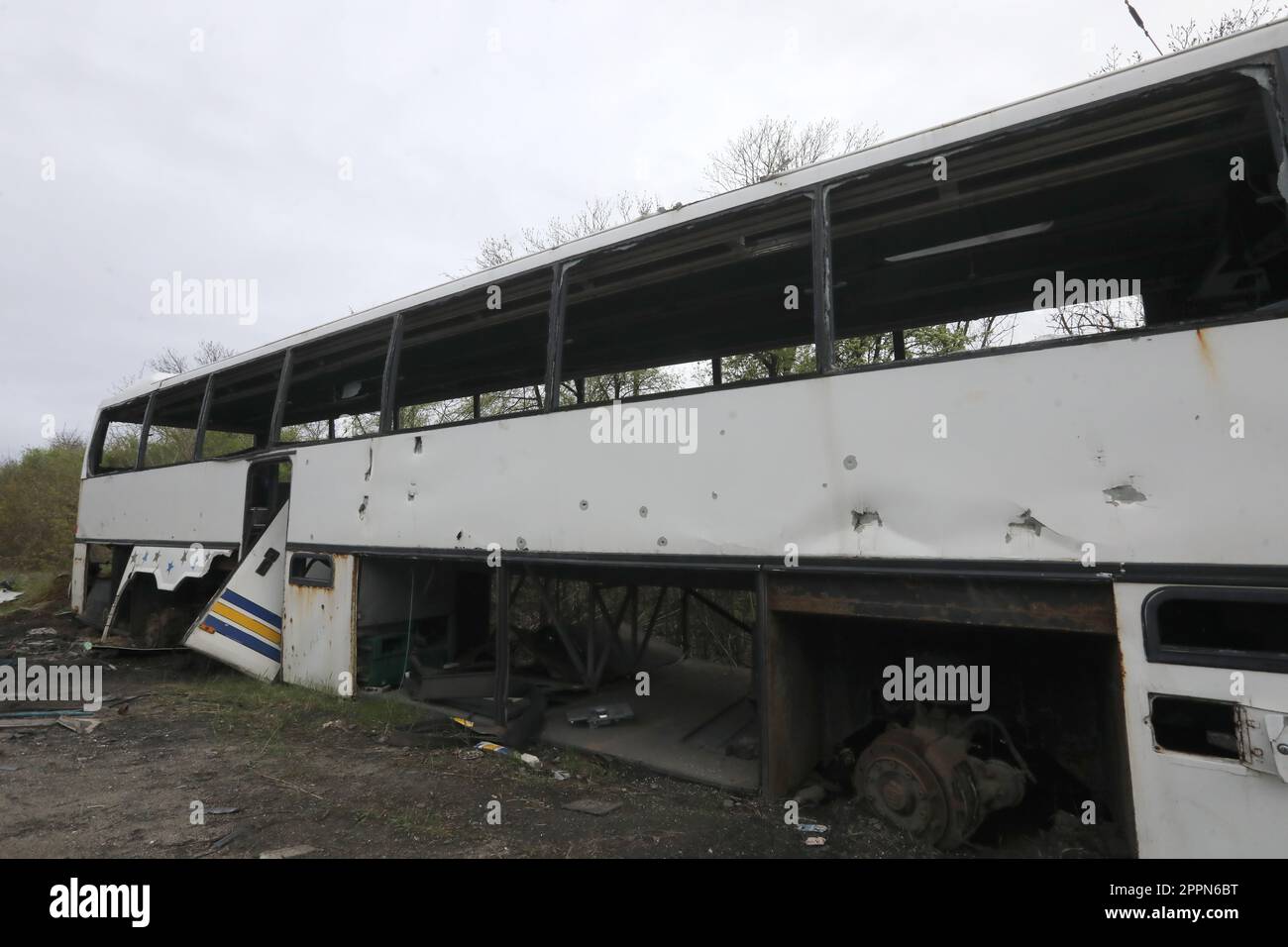 UKRAINE - APRIL 22, 2023 - A destroyed bus is left by the side of a ...