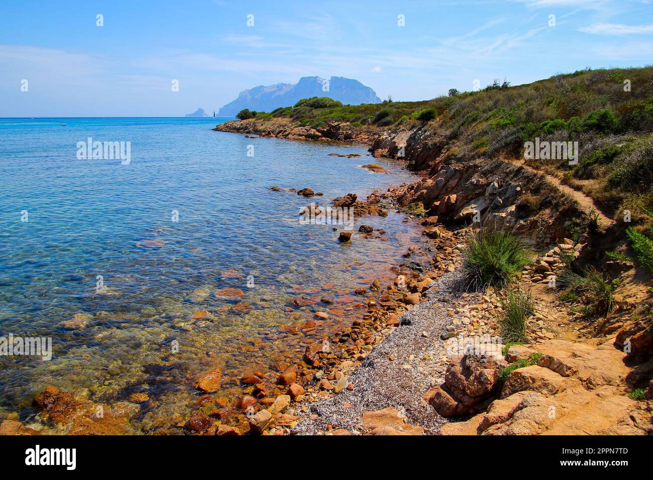 Shallow waters on a small pebbles beach in the bay of Porto Istana on ...