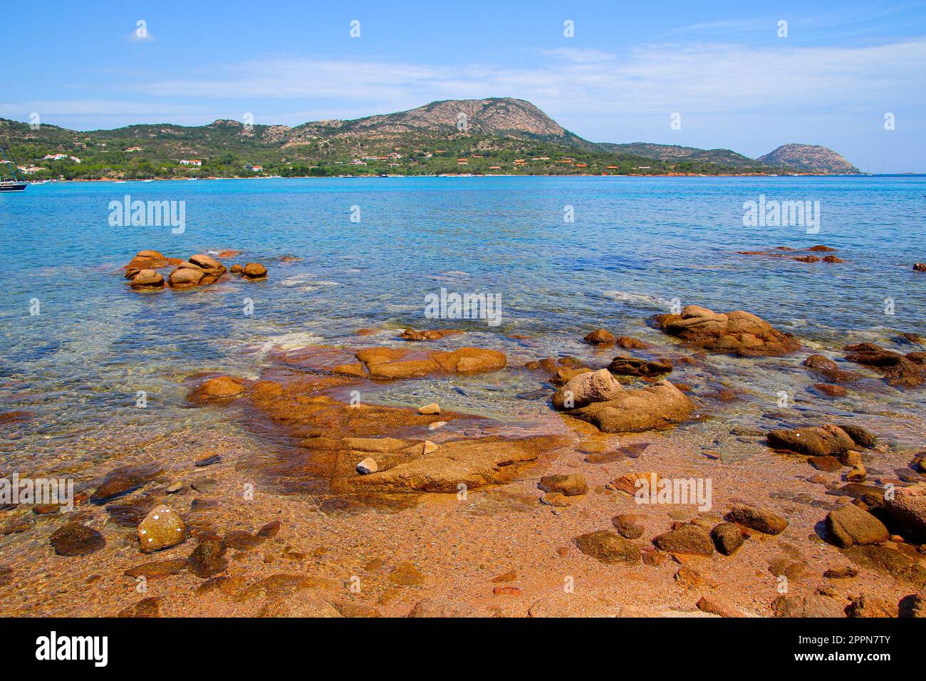 Semi-submerged rock in the blue waters of the Mediterranean Sea on the ...