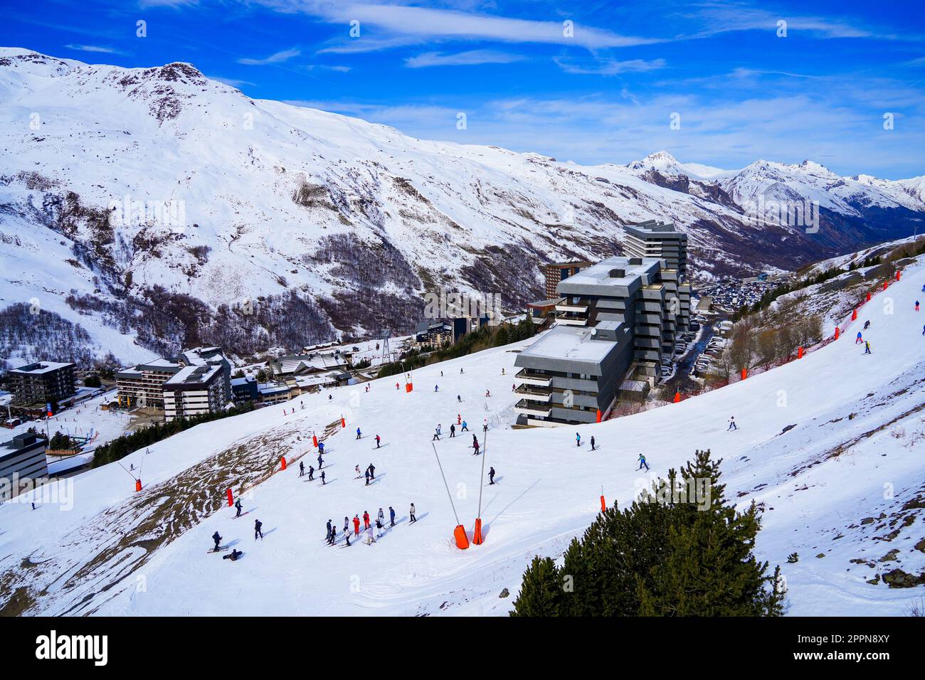 Large residential building surrounded by ski slopes on a mountainside ...