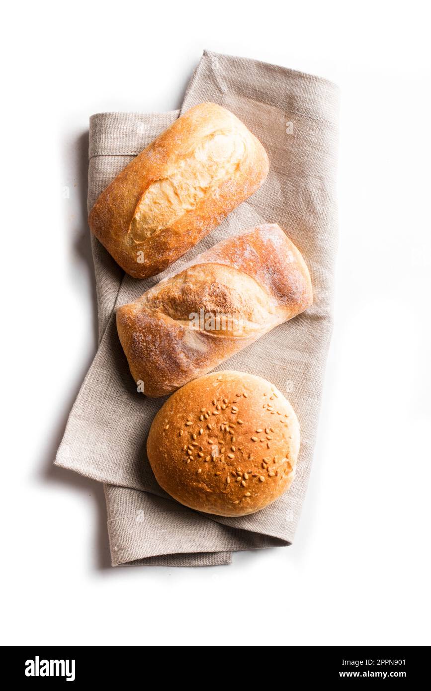 Fresh homebaked artisan bread. Three mini bread buns on linen napkin ...
