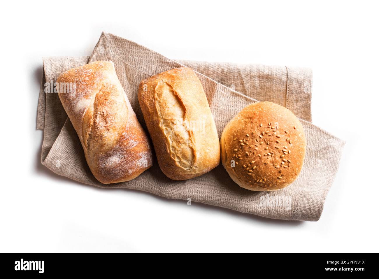 Fresh homebaked artisan bread. Three mini bread buns on linen napkin ...