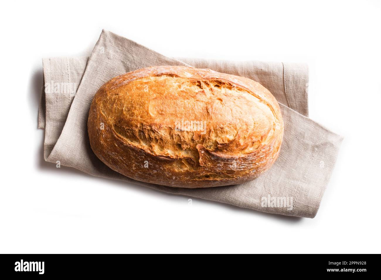 Fresh artisan bread. Loaf of bread on linen napkin isolated on white ...