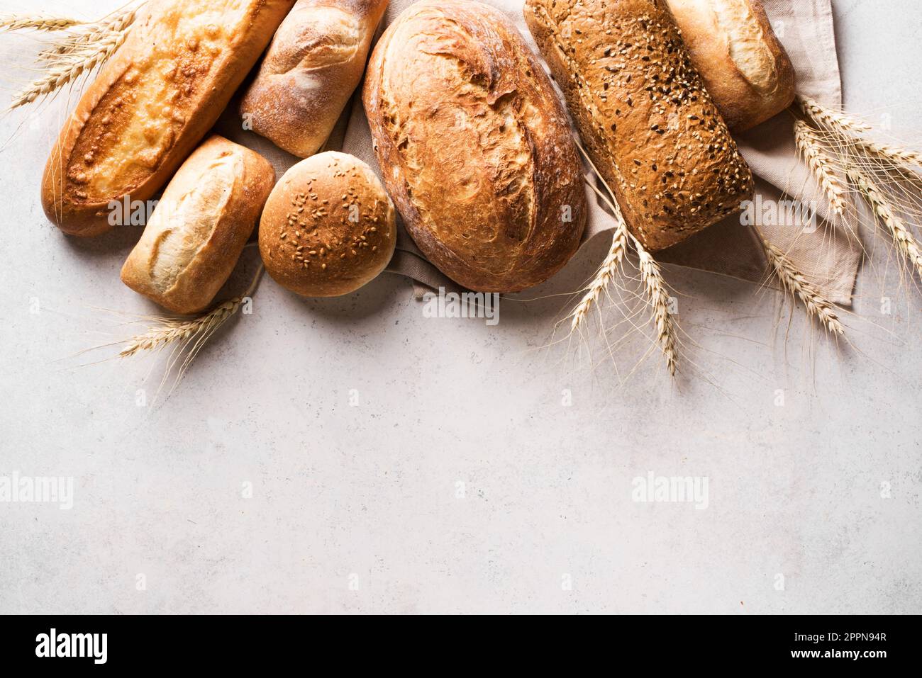 Assortment of various delicious freshly baked bread on white background ...
