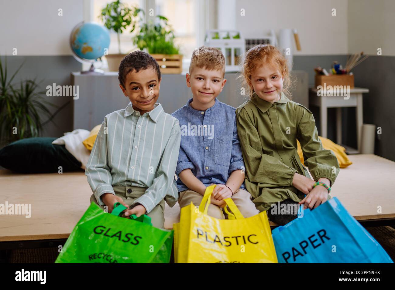 Children separating rubish in to three bins Stock Photo - Alamy