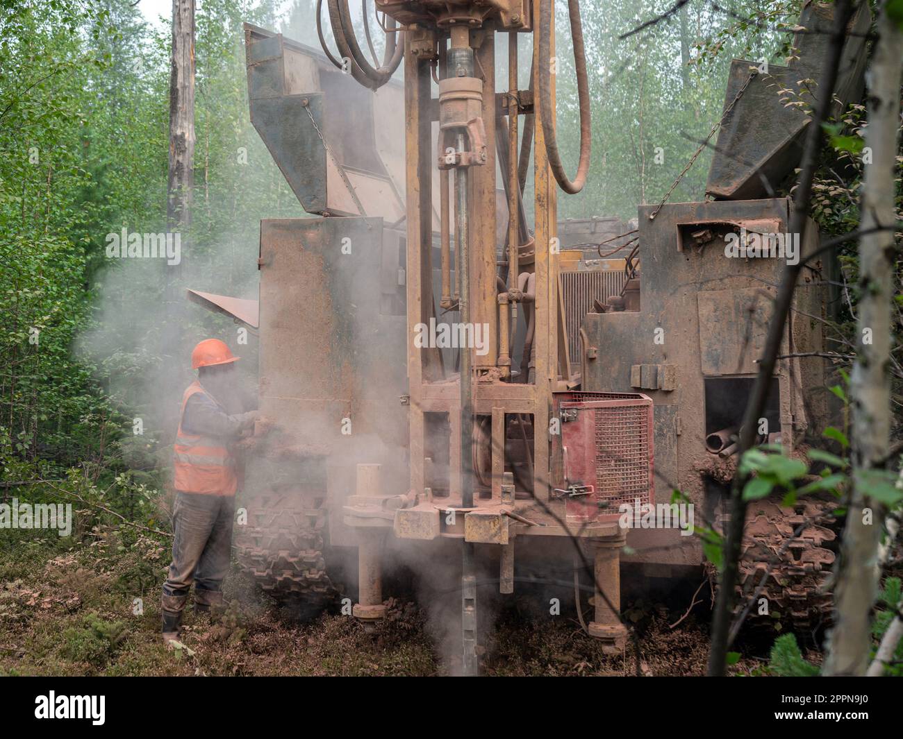 Crawler drilling rig drills well, lot of dust when drilling borehole ...