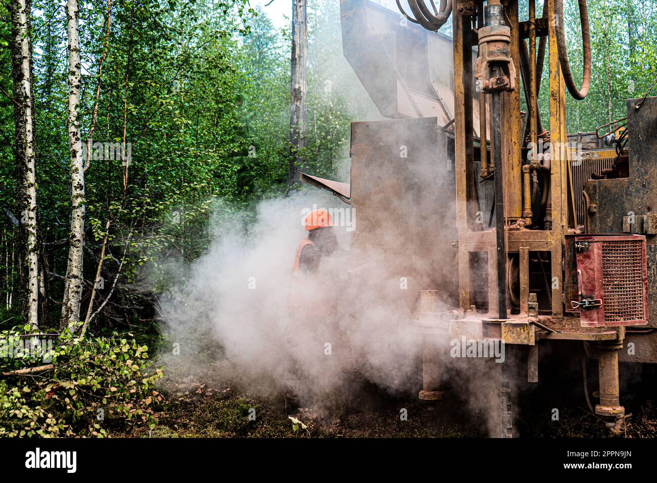 Drilling rig while drilling well. lot of dust during geological ...