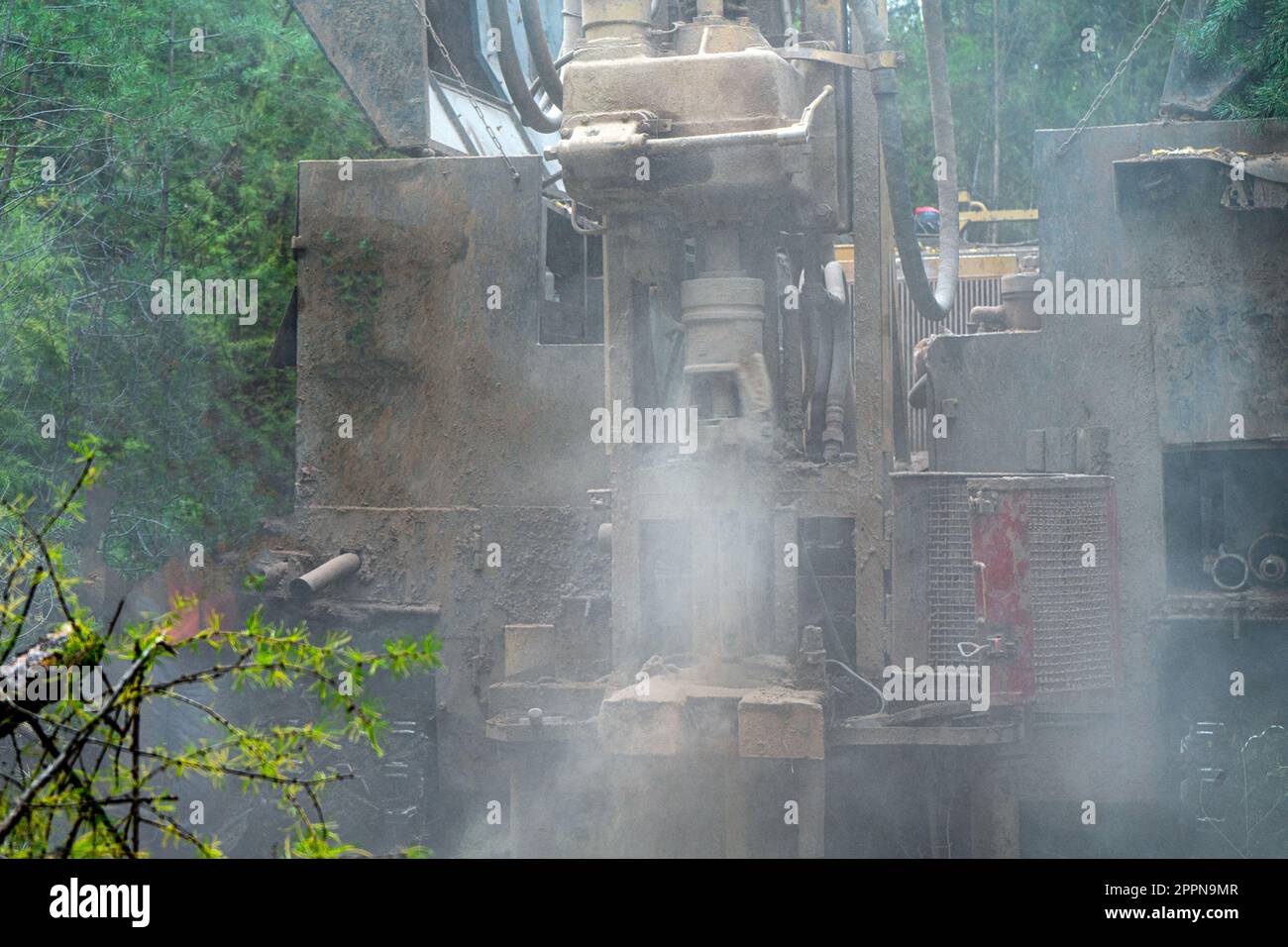 Crawler drilling rig drills a well, a lot of dust when drilling a ...