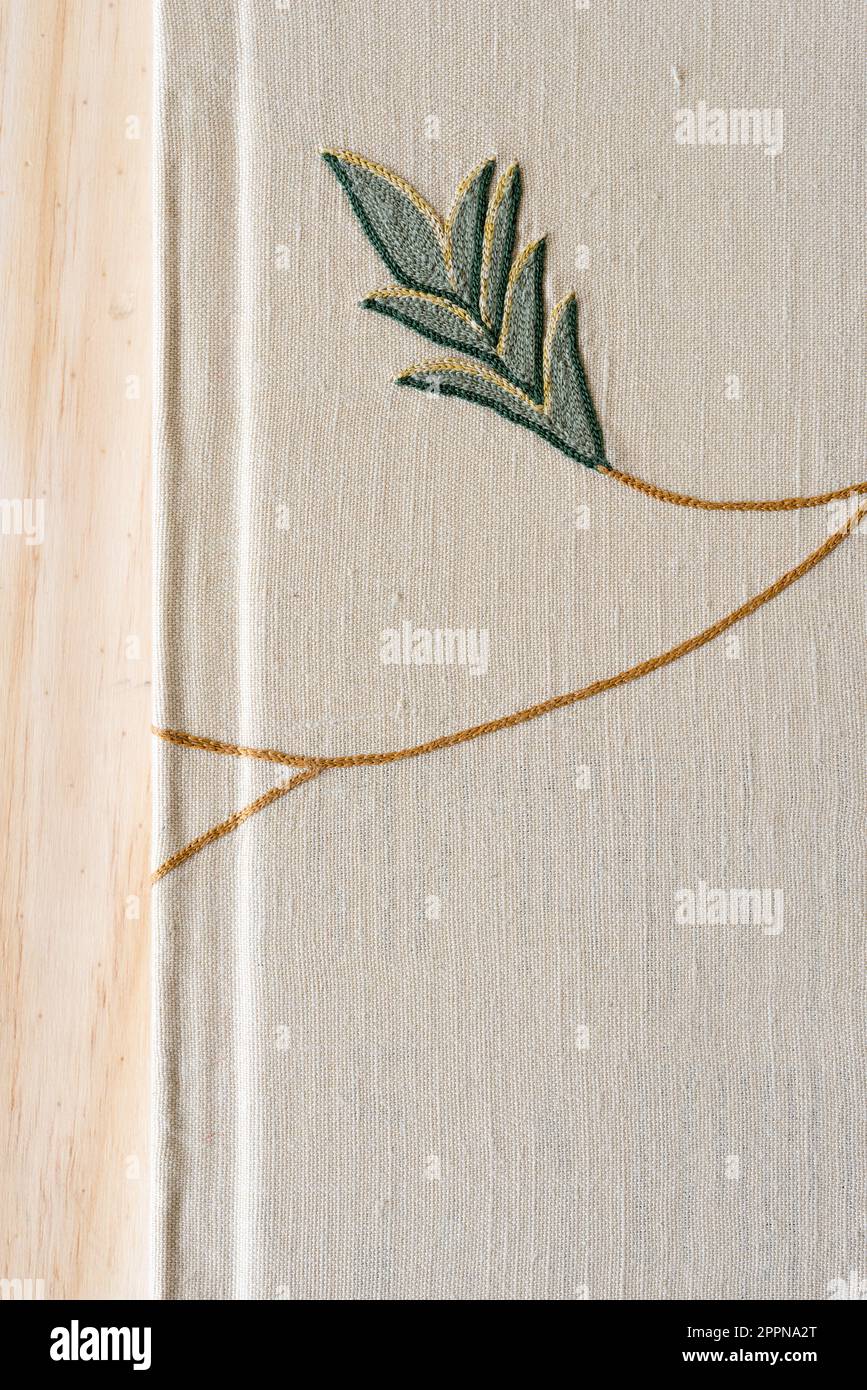 edge of book cloth with machine embroidery featuring decorative floral ...