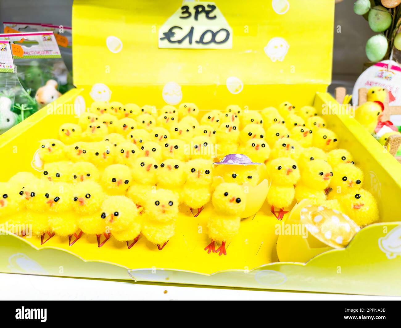 Festive photo of artificial cute chicks in a store display, adding a ...