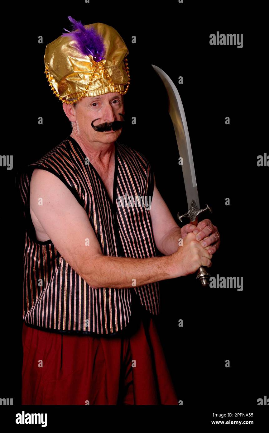 An elder sultan or shiek with a sword isolated over black Stock Photo ...