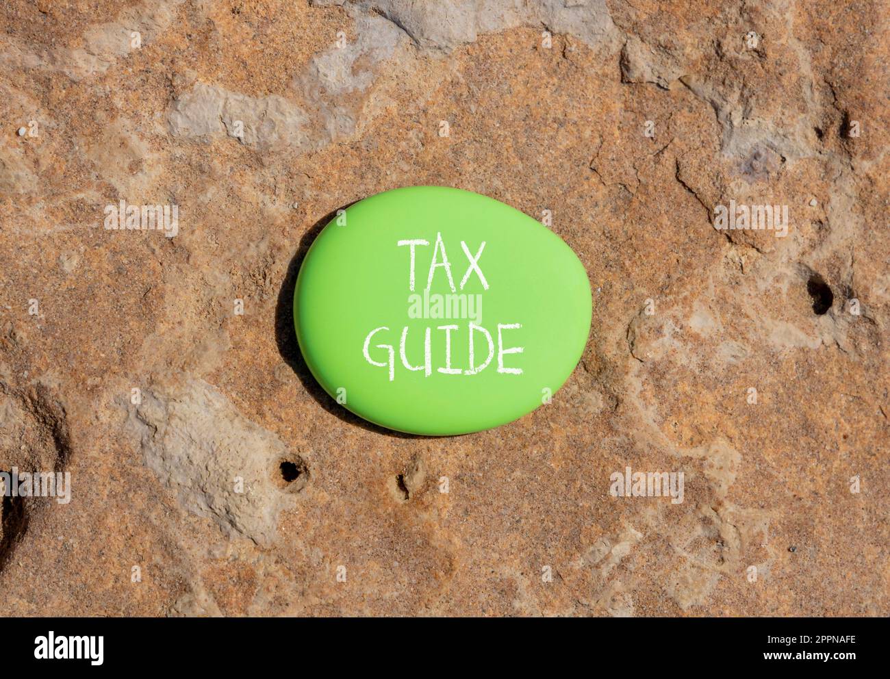 Tax guide symbol. Concept words Tax guide on beautiful green stone ...