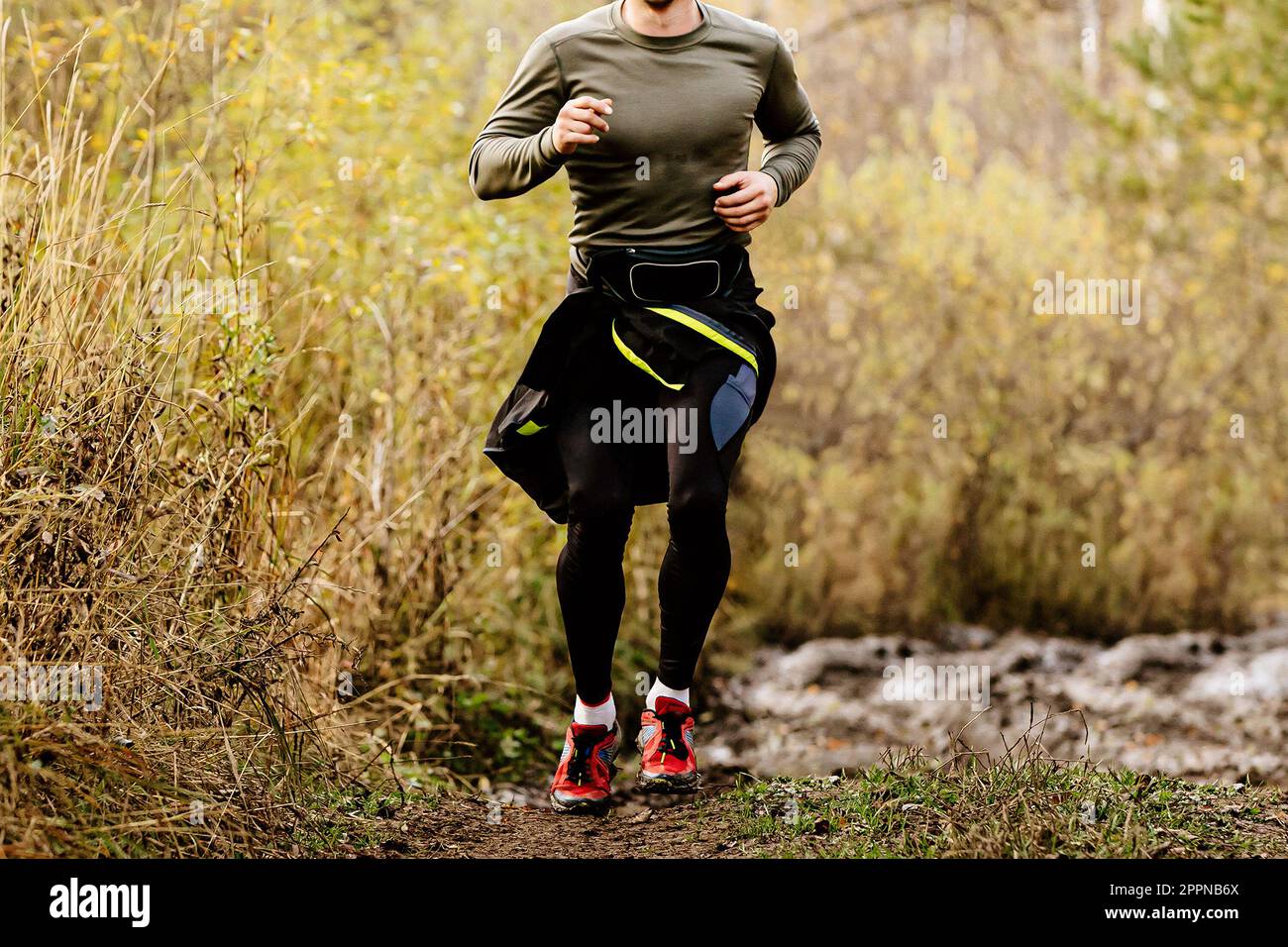 male runner running on autumn trail marathon, cross-country running ...