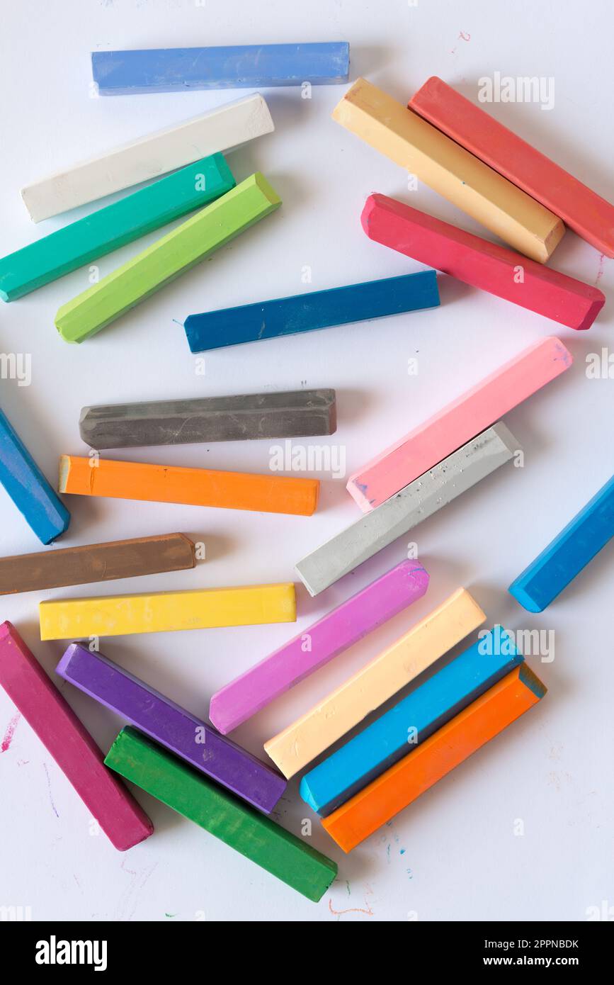 multiple chalk pastels on a white paper background Stock Photo - Alamy