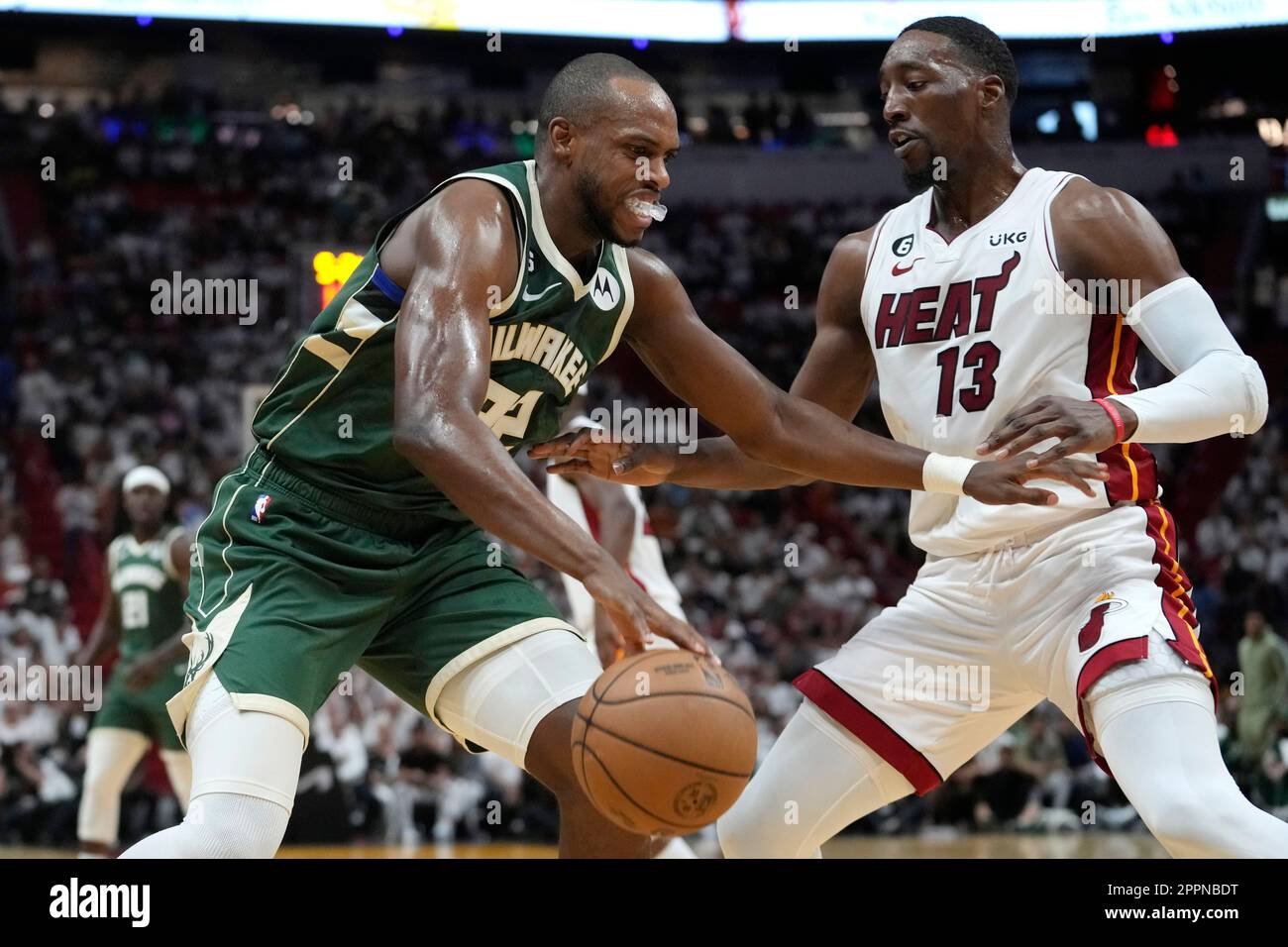 Milwaukee Bucks forward Khris Middleton (22) drives to the basket as Miami Heat center Bam ...
