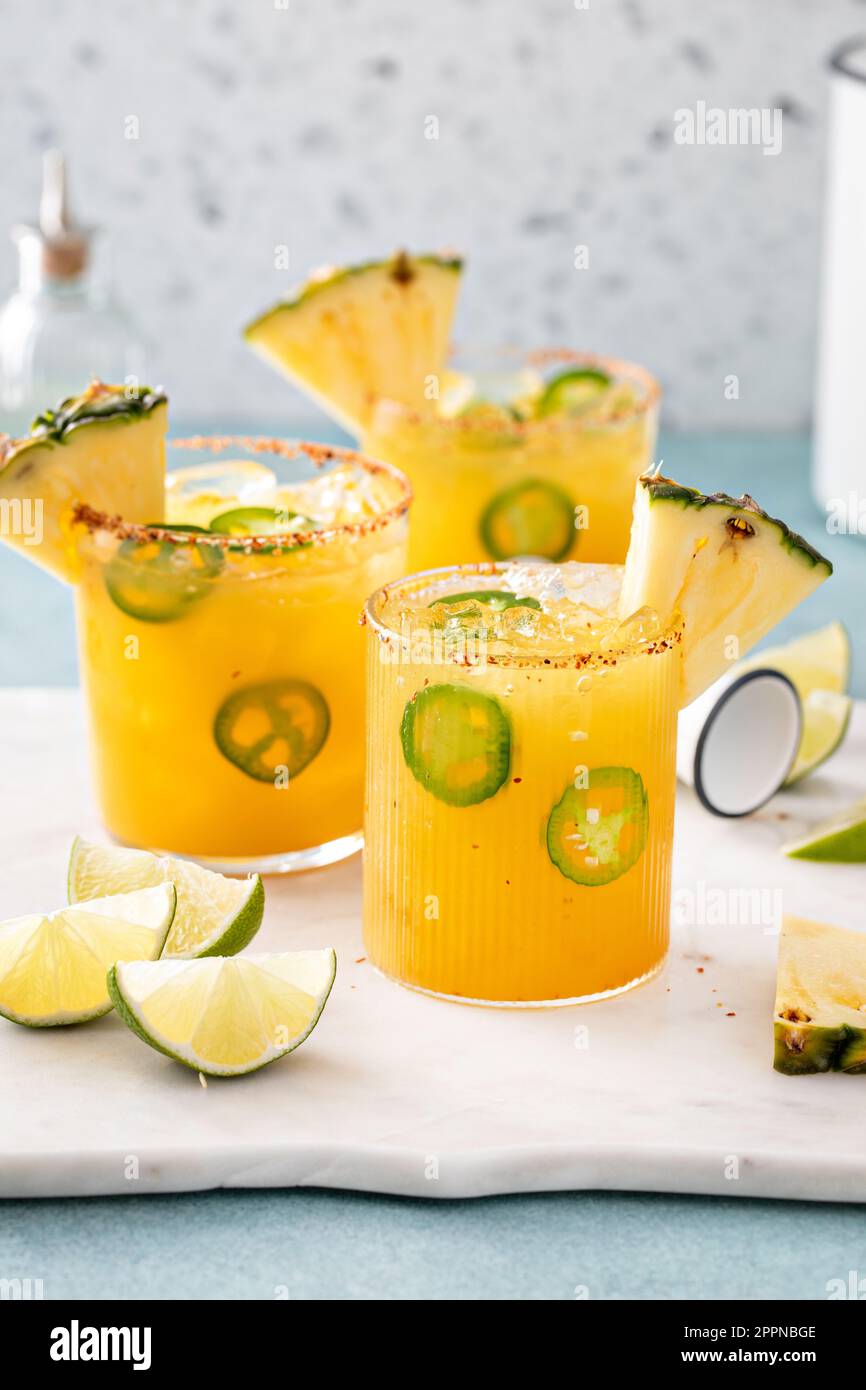 Pineapple spicy margarita cocktail in glasses with chili tajin rim ...