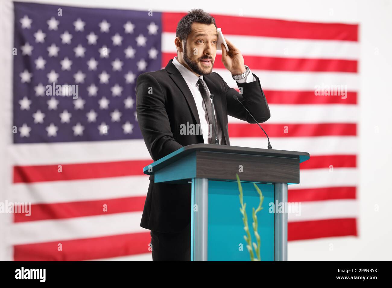 Stressed businessman preparing for a speech on a podium in front of the ...