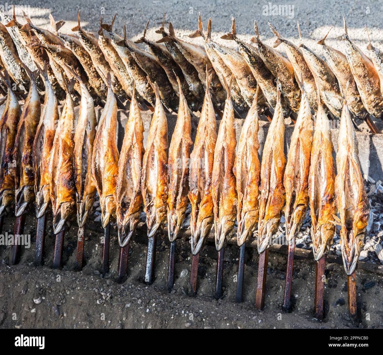 Steckerlfisch (grilled fish on a stick) - traditional meal seen on ...
