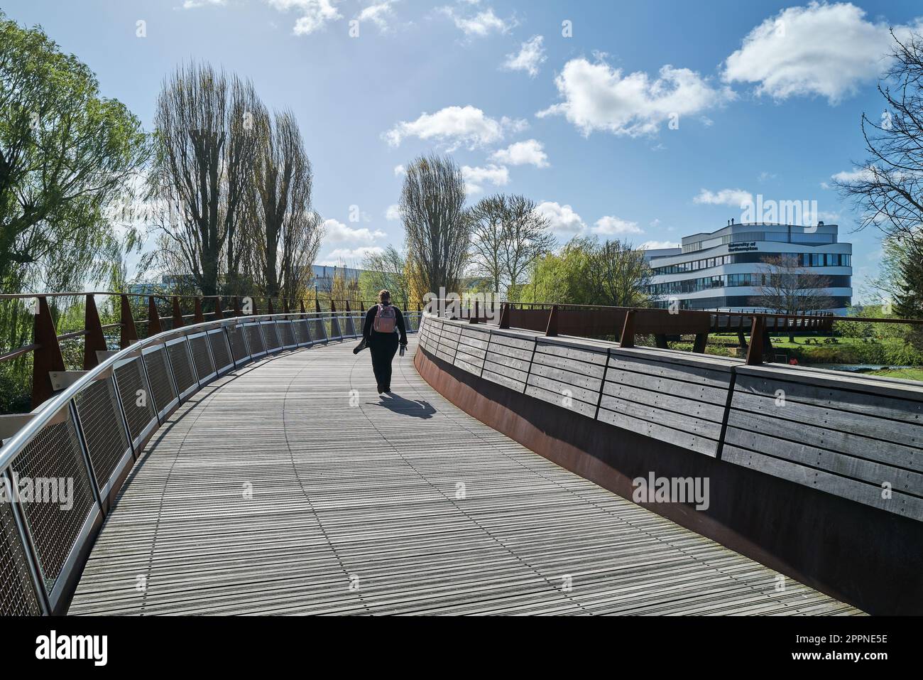 A student walks along the Becket bridge over the river nene to UON, the University of ...