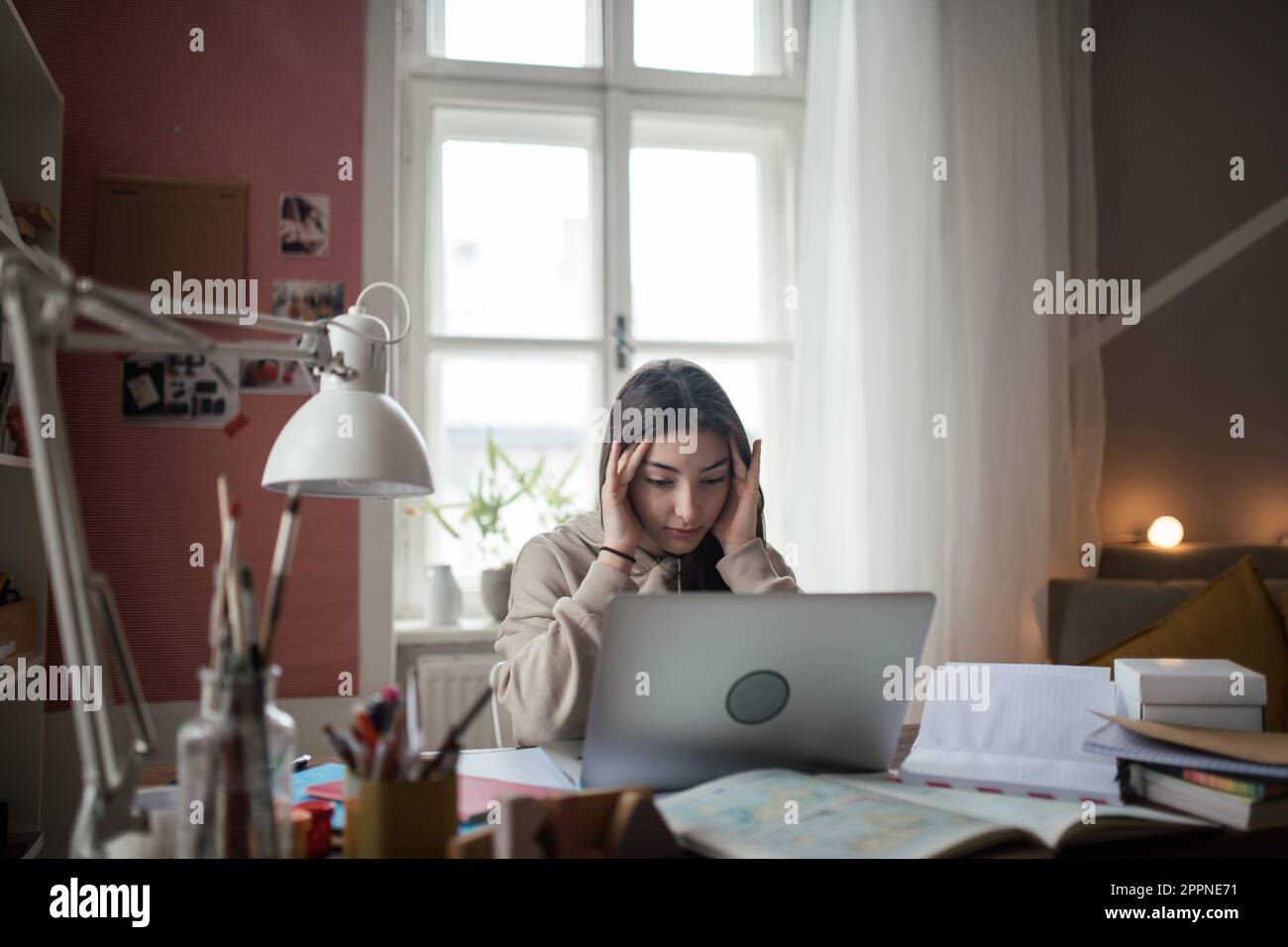 Young teenage girl studying in her room Stock Photo - Alamy