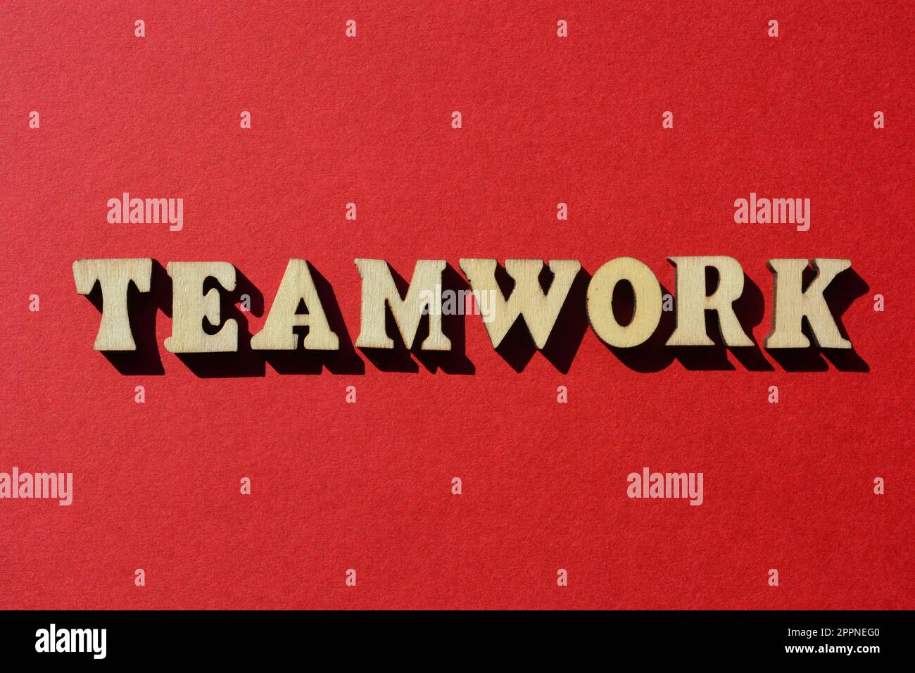 Teamwork, word in wooden alphabet letters isolated on red background ...