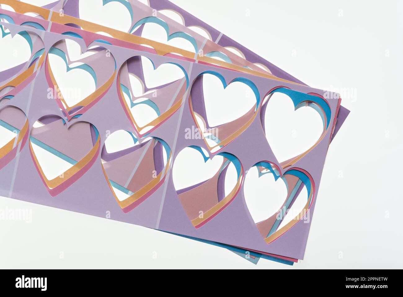 paper stencils with heart shape cutouts on a white background Stock ...