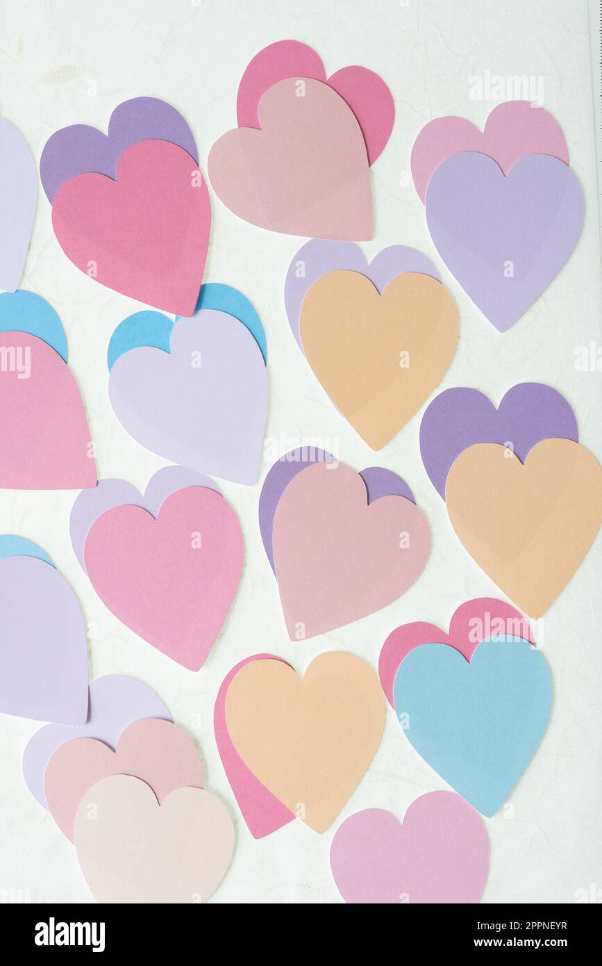 multiple machine-cut paper hearts on an illuminated background Stock ...