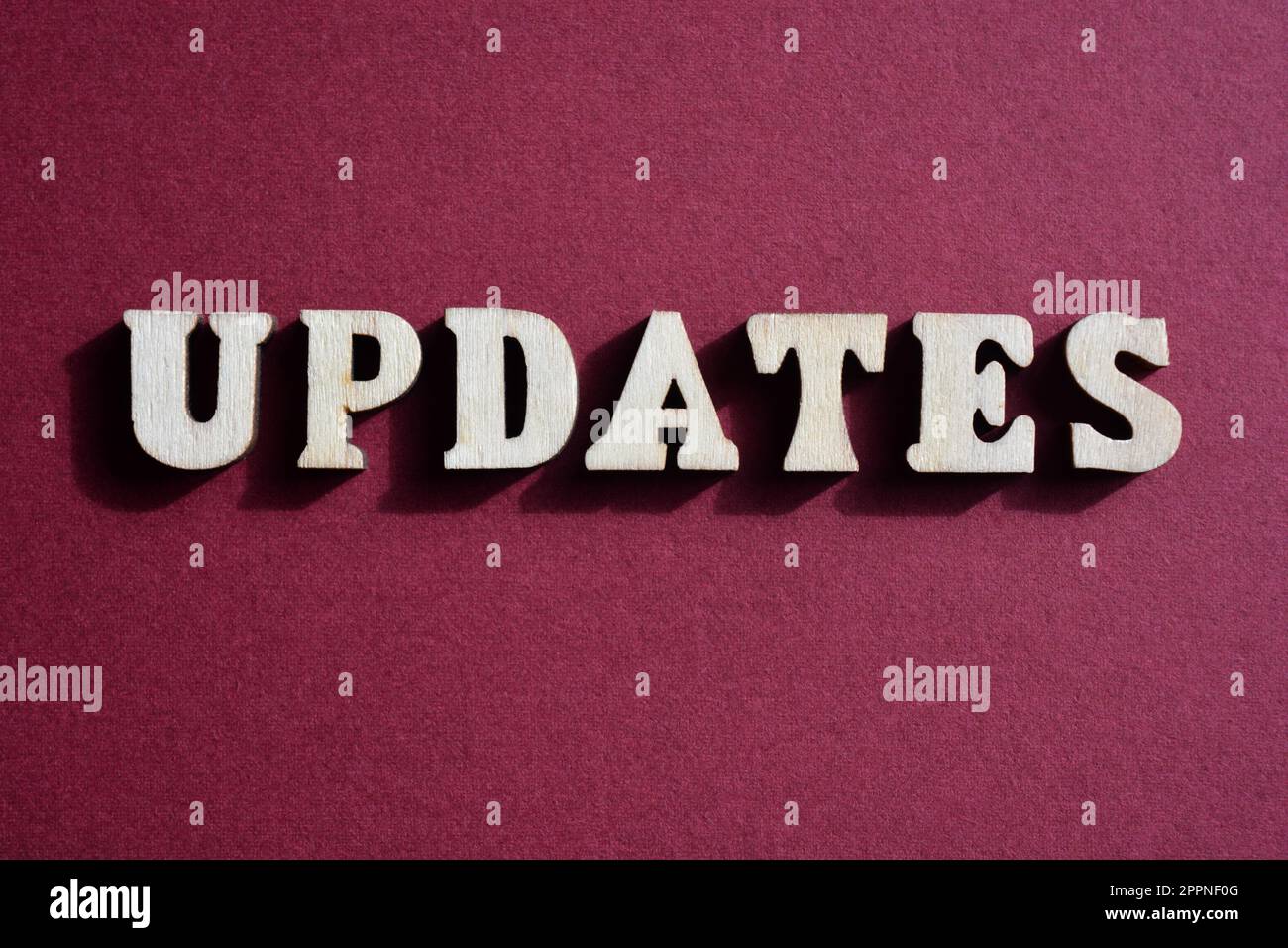 Updates, word in wooden alphabet letters isolated on background Stock ...