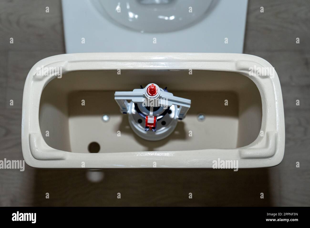 white toilet tank with an open lid and flush system. Plastic toilet ...