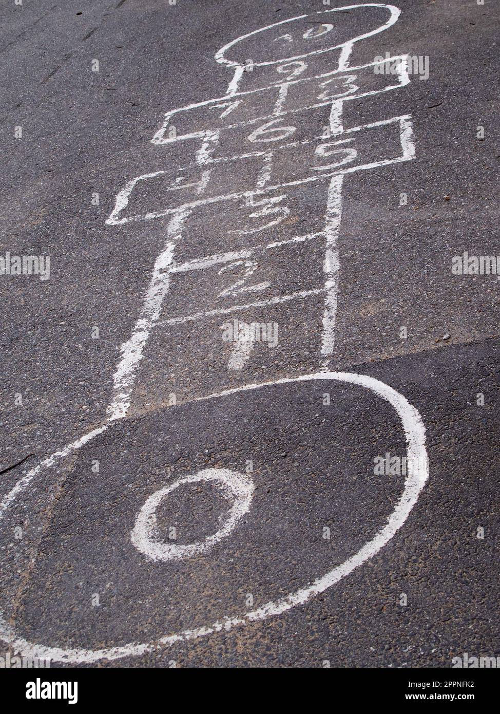 Hopscotch figure as street painting on asphalt at childrens playground ...