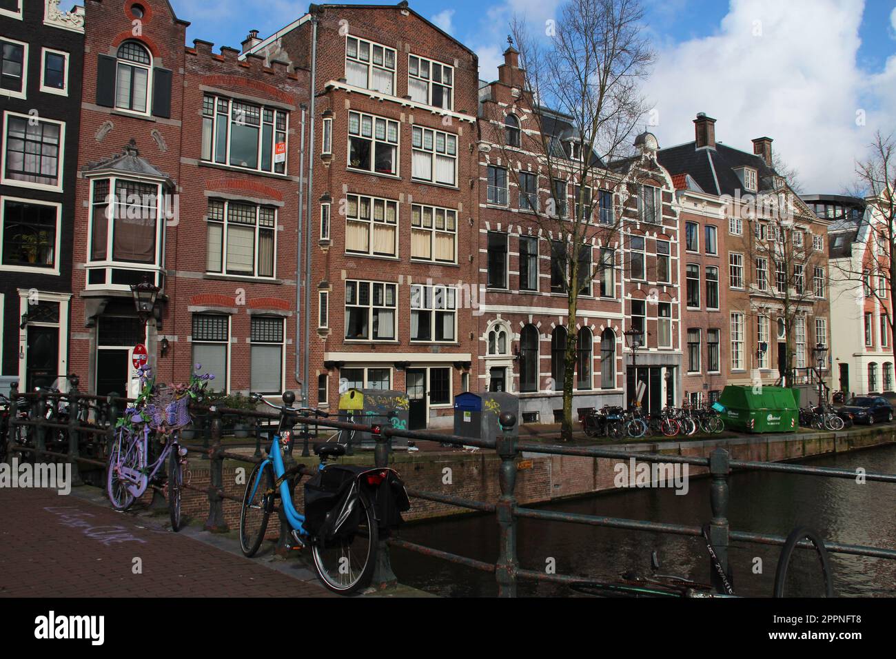 canal, river and old brick houses or flat buildings in amsterdam (the ...