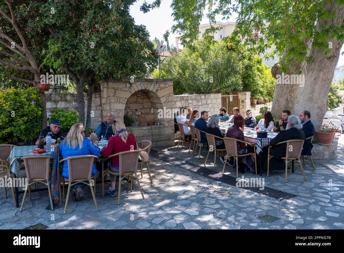 Customers enjoy Sunday lunch outside at the Platanos Tavern, Lania ...