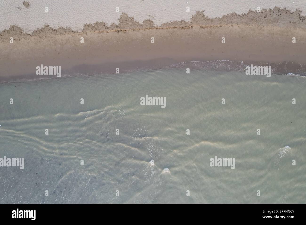 Shallow water of sea on the sandy beach with muddy water in Karpen ...