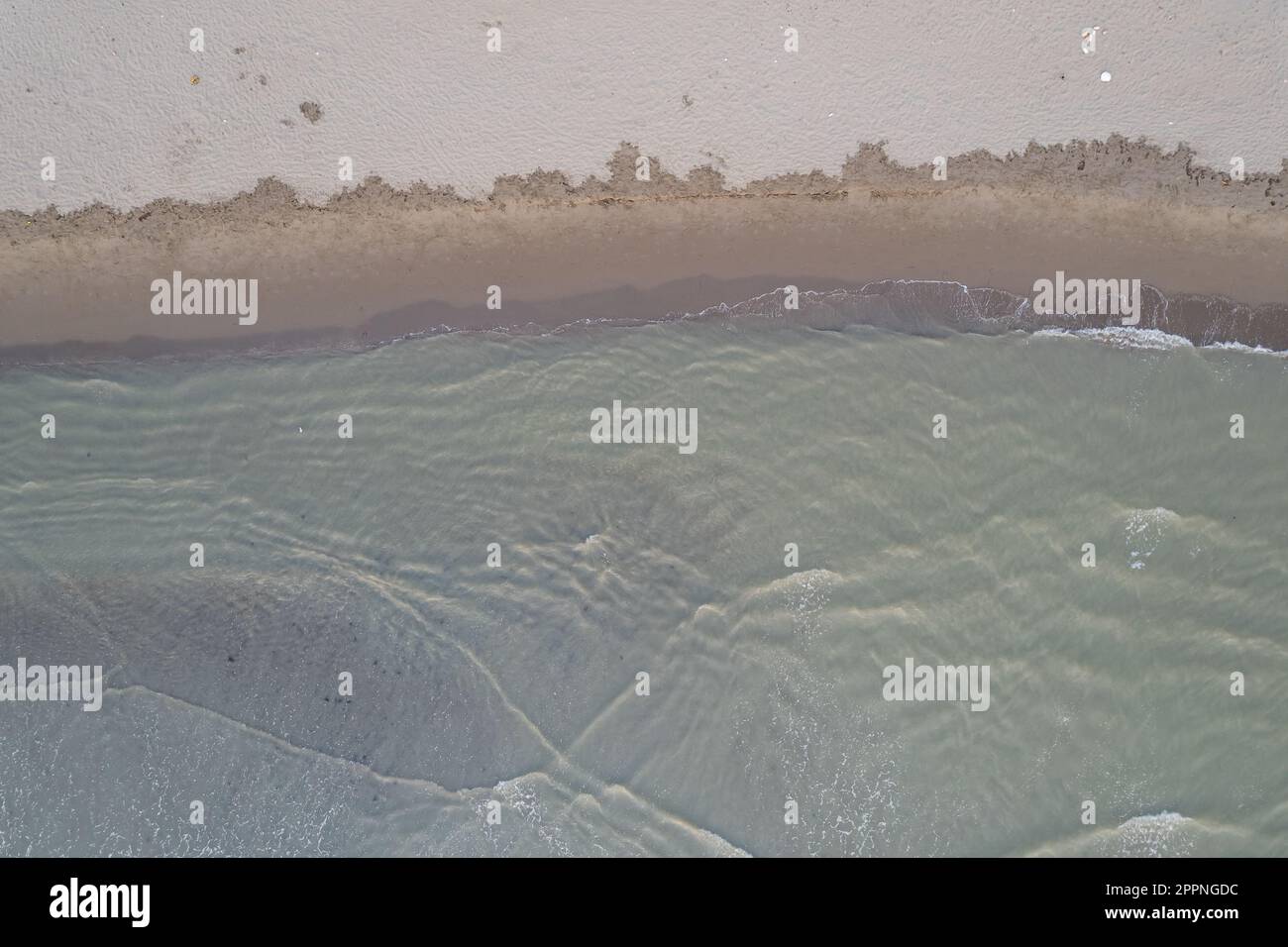 Shallow water of sea on the sandy beach with muddy water in Karpen ...