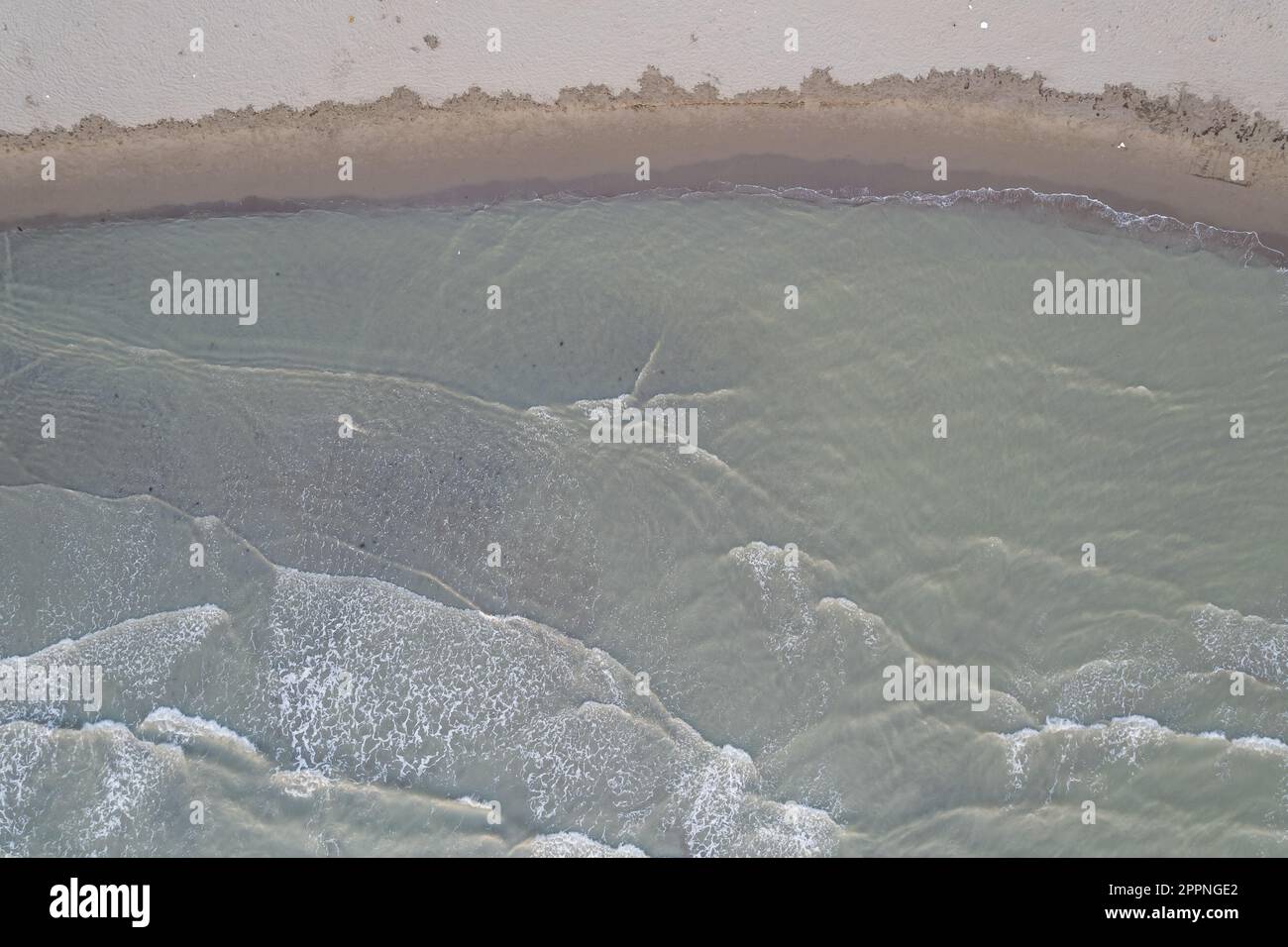 Shallow water of sea on the sandy beach with muddy water in Karpen ...