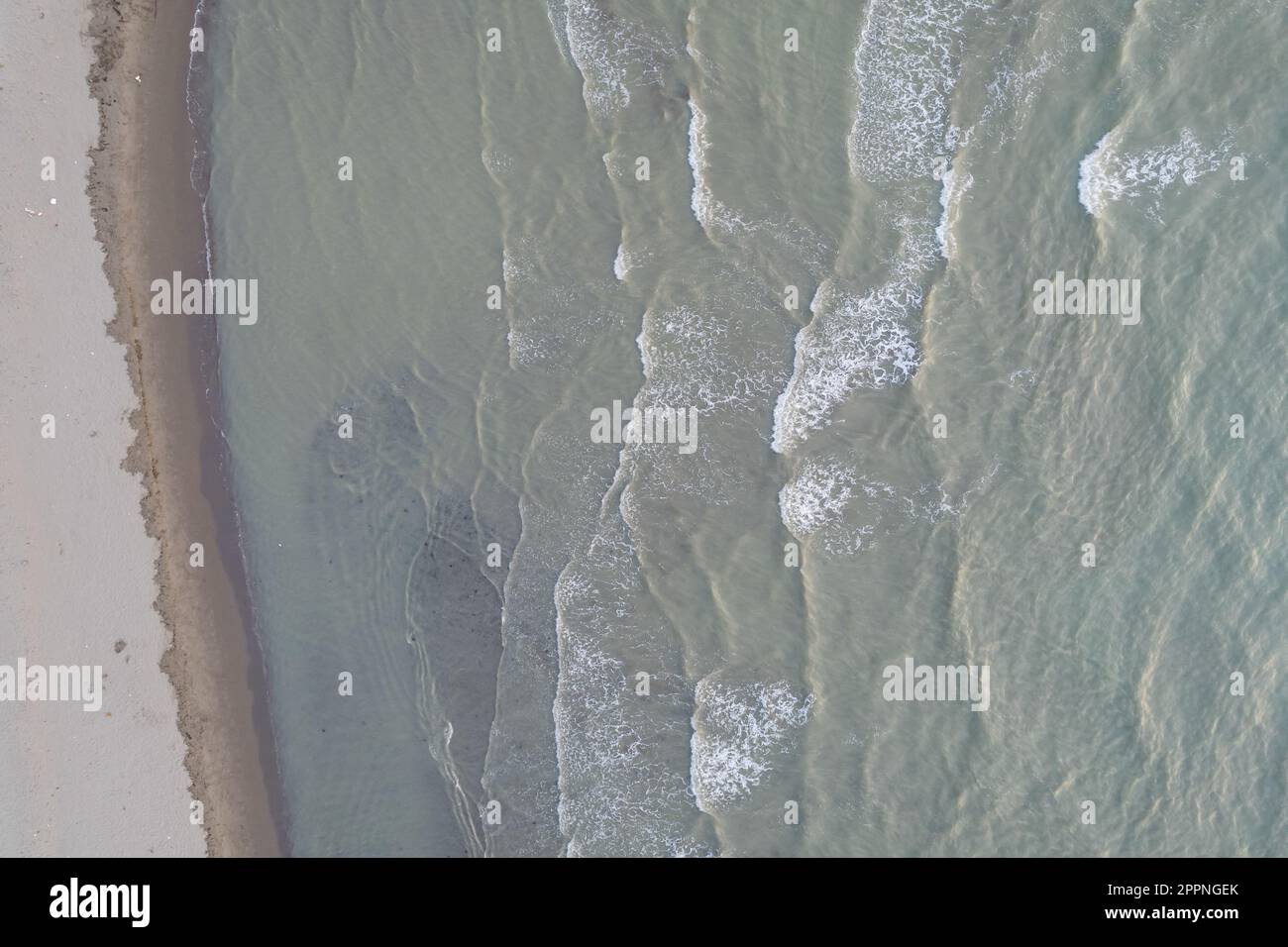 Shallow water of sea on the sandy beach with muddy water in Karpen ...