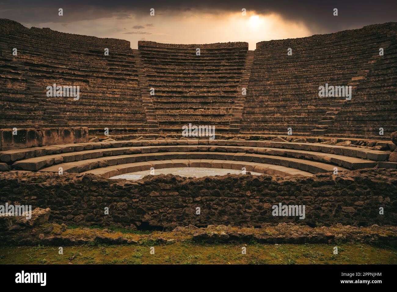 A traditional open-air Amphitheatre of Pompeii in Italy under a cloudy ...