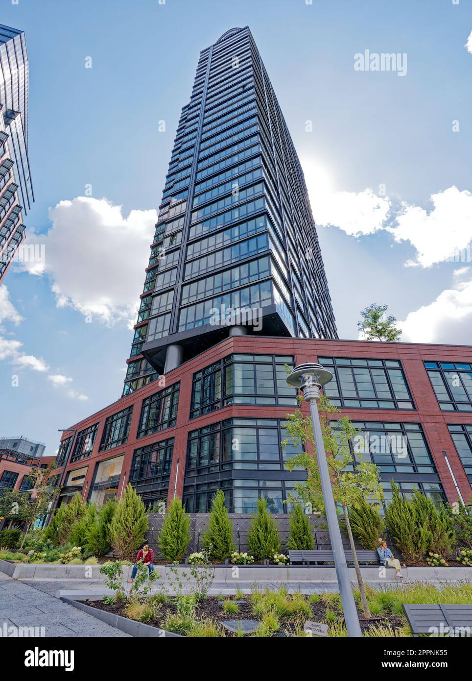 Two Blue Slip is a brick and glass tower capped by curved-façade ...