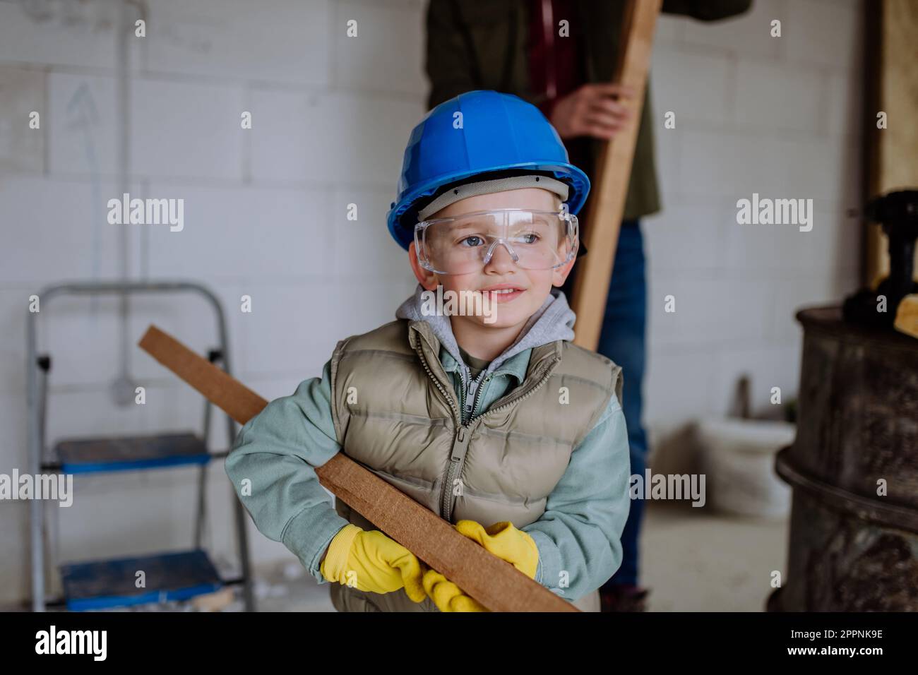 Little boy helping his father at their unfinished house Stock Photo - Alamy