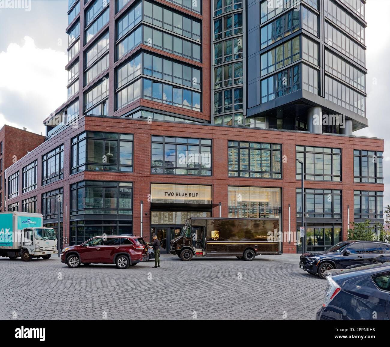 Two Blue Slip is a brick and glass tower capped by curved-façade ...