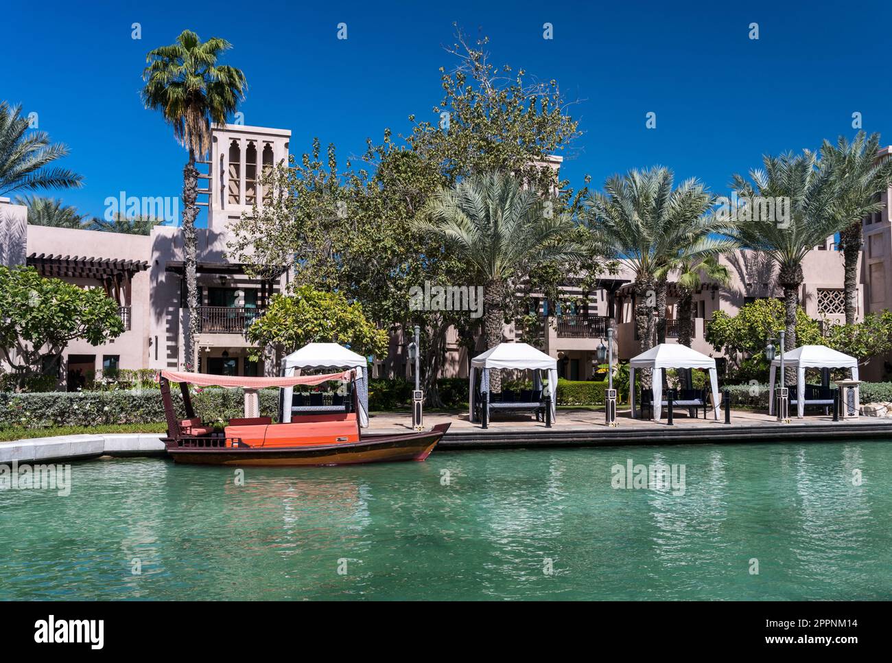 Small dhow docked by bank of waterway around Souk Madinat Jumeirah in ...