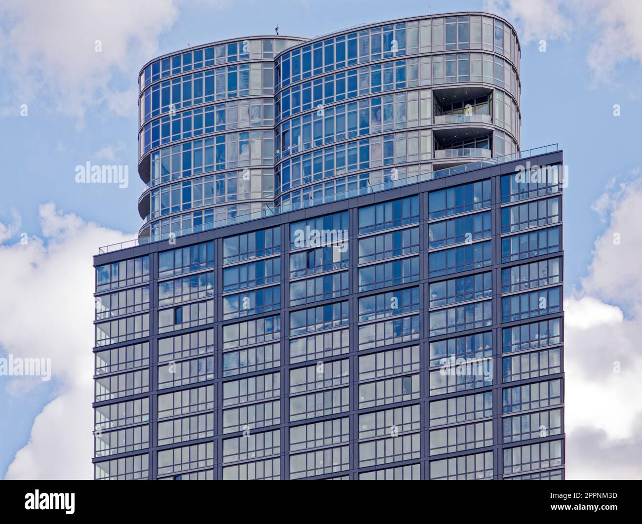 Two Blue Slip is a brick and glass tower capped by curved-façade ...
