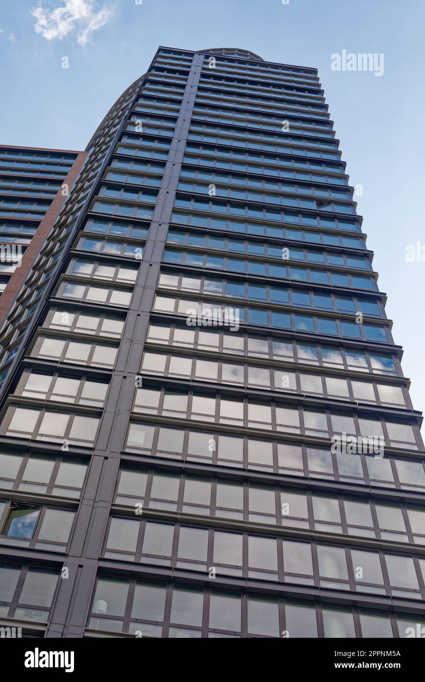 Two Blue Slip is a brick and glass tower capped by curved-façade ...