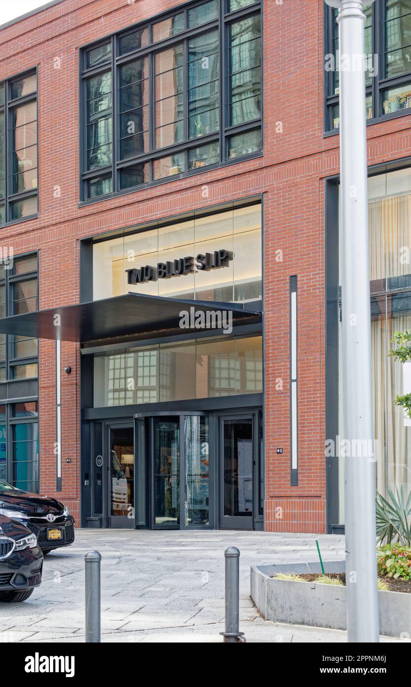 Two Blue Slip is a brick and glass tower capped by curved-façade ...